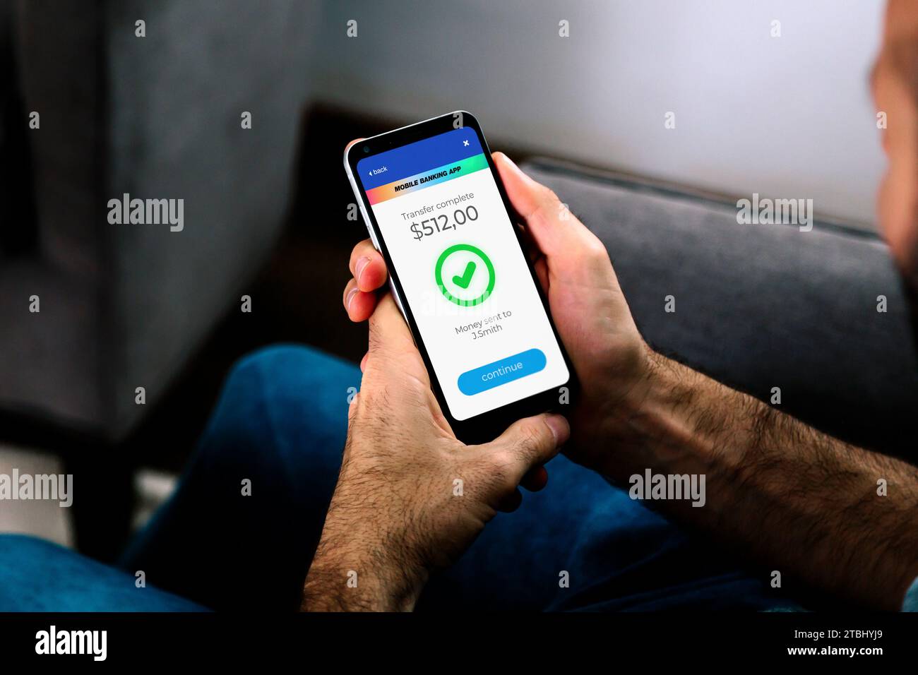 Mobile phone with a financial application on screen. Man transfers ...