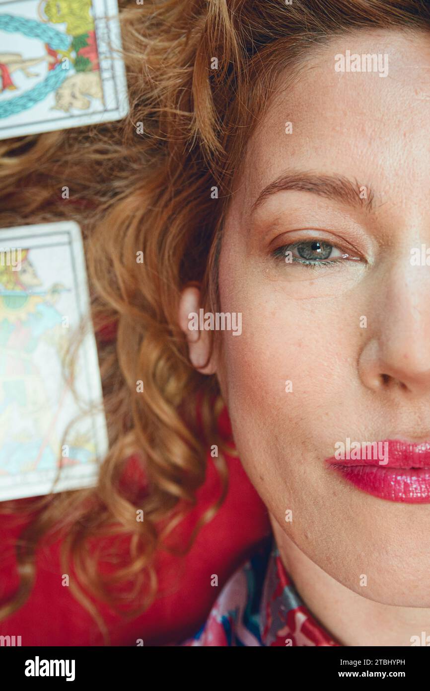 Beautiful half-face portrait of young Latin tarot reader woman, looking ...