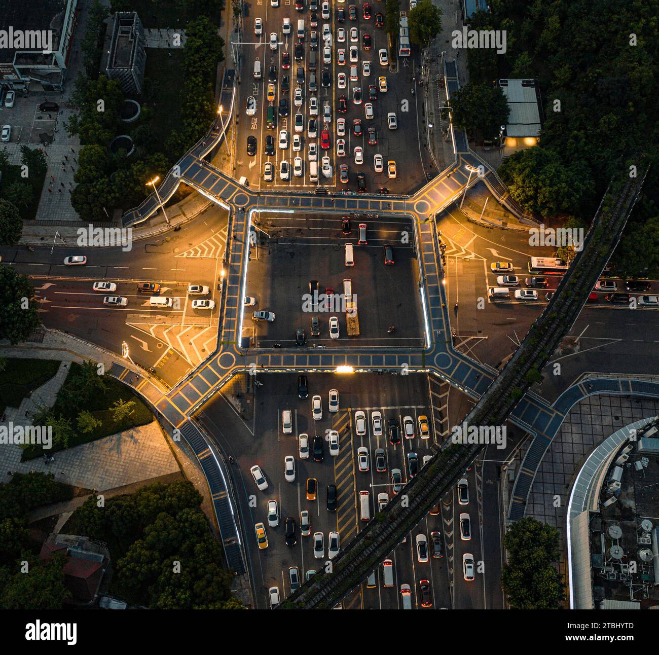 An aerial view of an intersection during the evening rush hour is ...