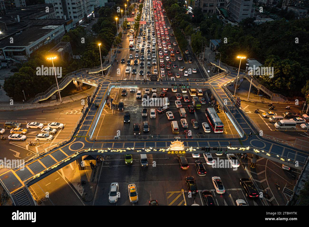 A nighttime aerial view of an intersection during the evening rush hour ...