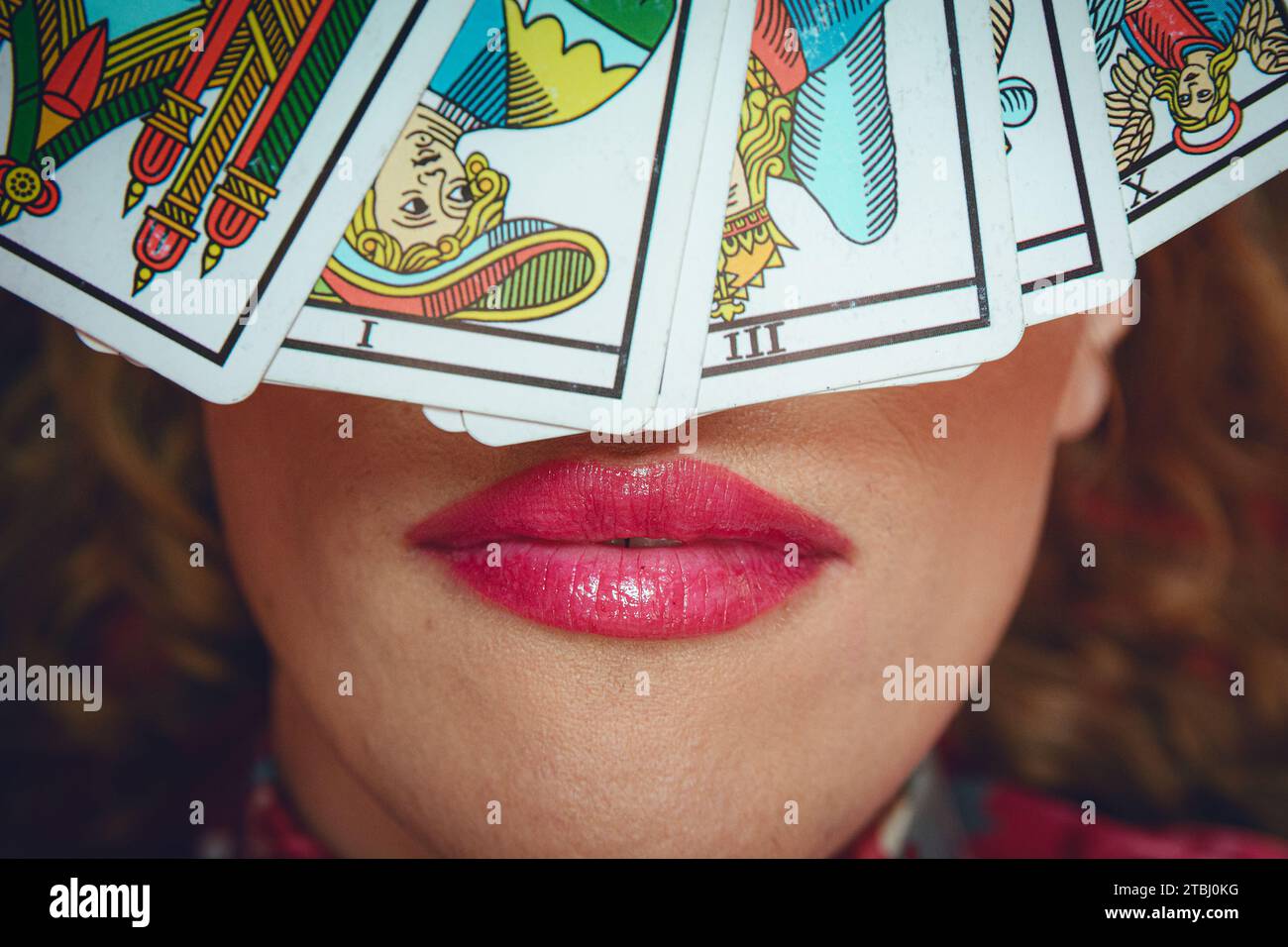 mysterious tarot reading woman lying down covers her face with cards ...
