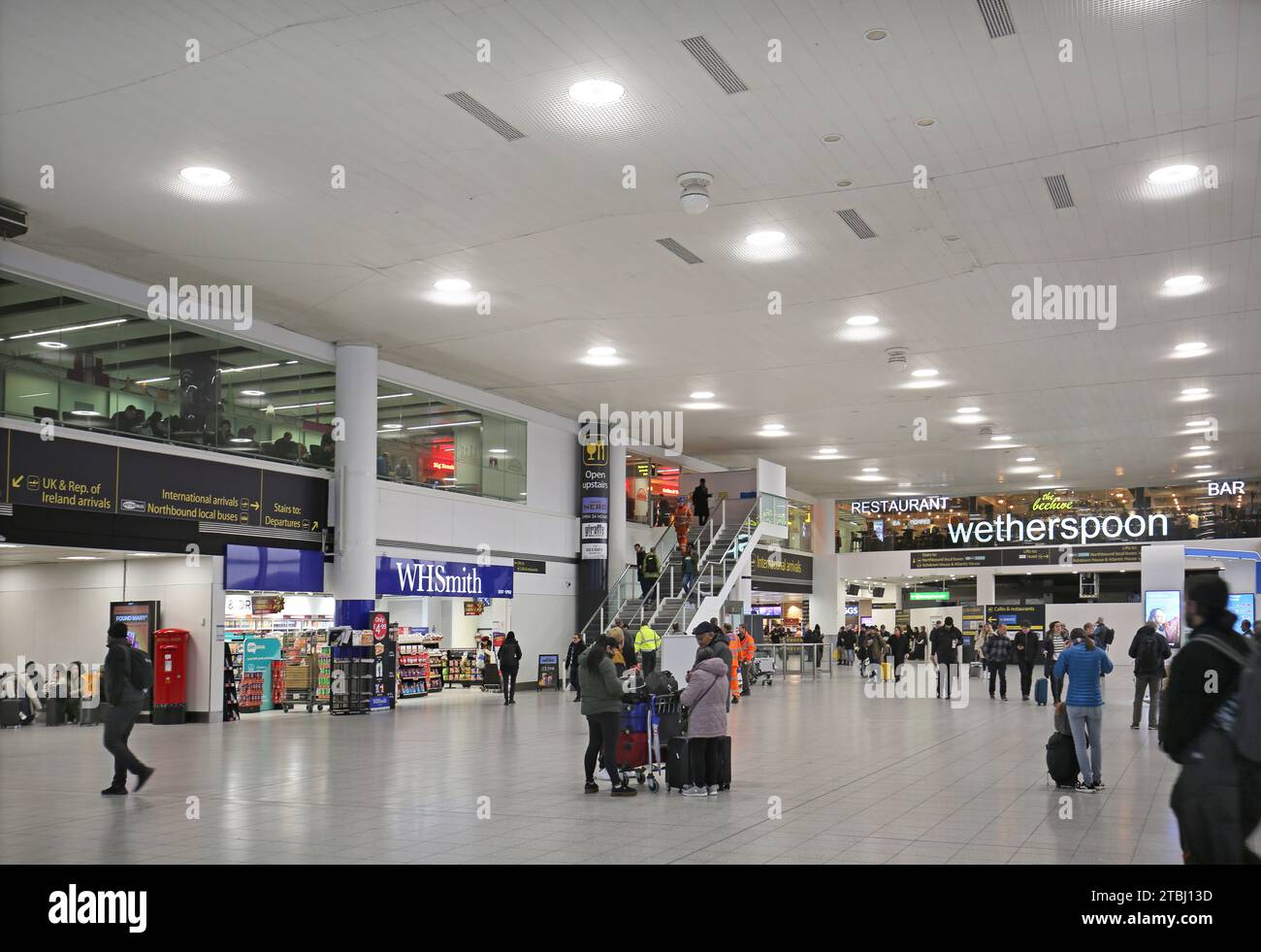 Gatwick Airport, South Terminal, check-in area. Shows passengers ...