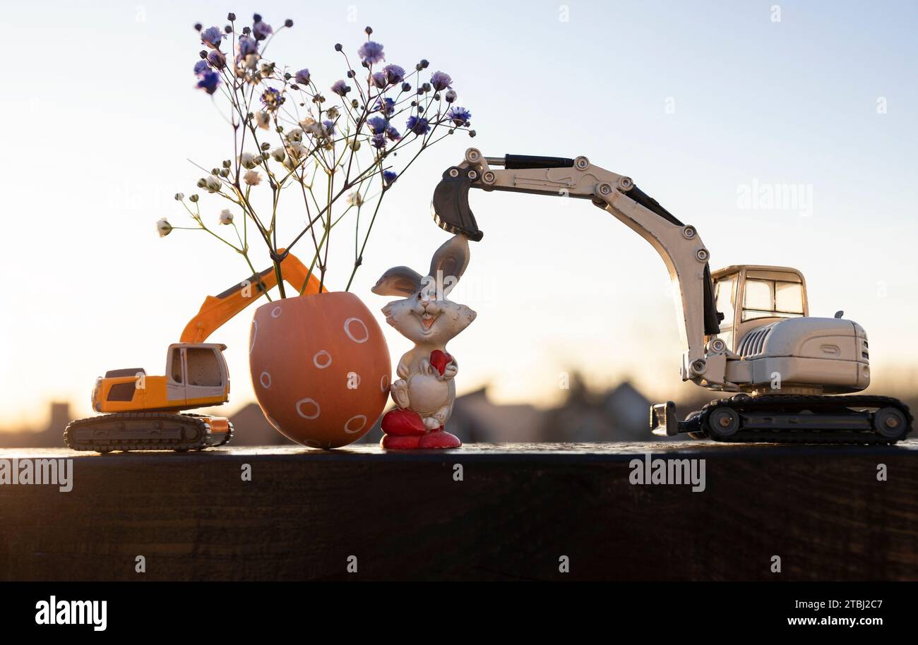 2 toy excavators, a painted egg with gypsophila flowers, an Easter ...