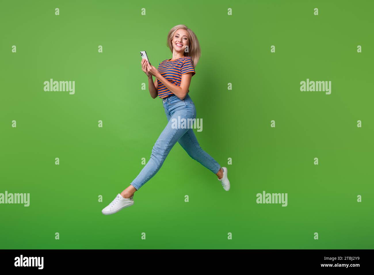 Full body length shot of funky lady browsing smartphone happy to see ...