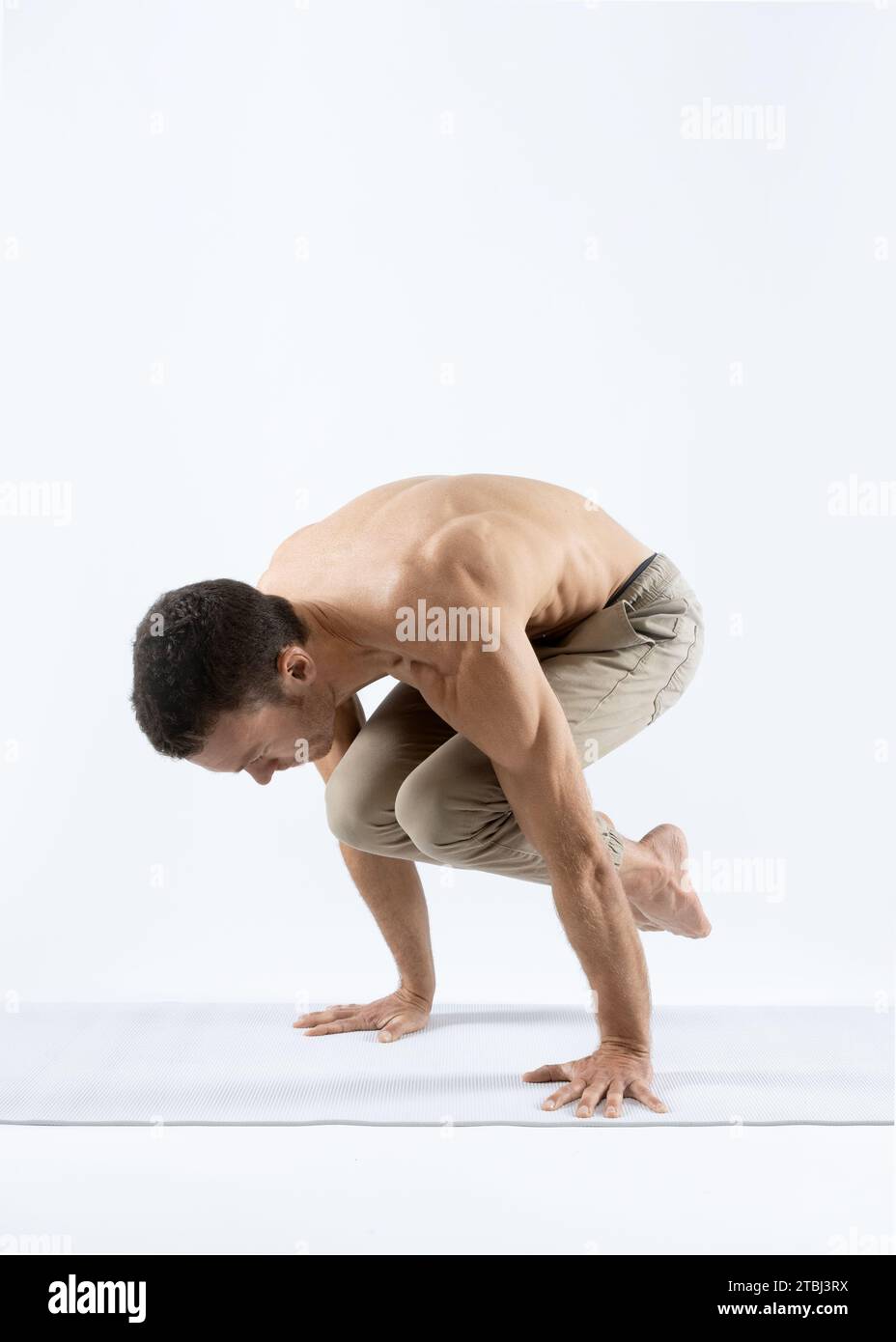 advanced male yogi doing crane pose (bakasana Stock Photo - Alamy