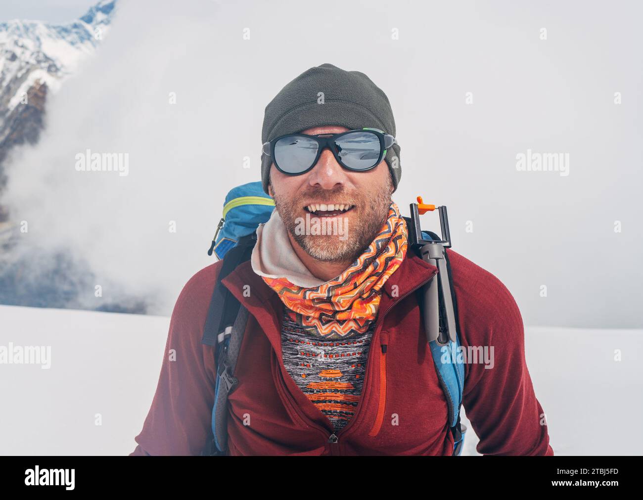 Cheerful laughing climber in sunglasses portrait with backpack ...