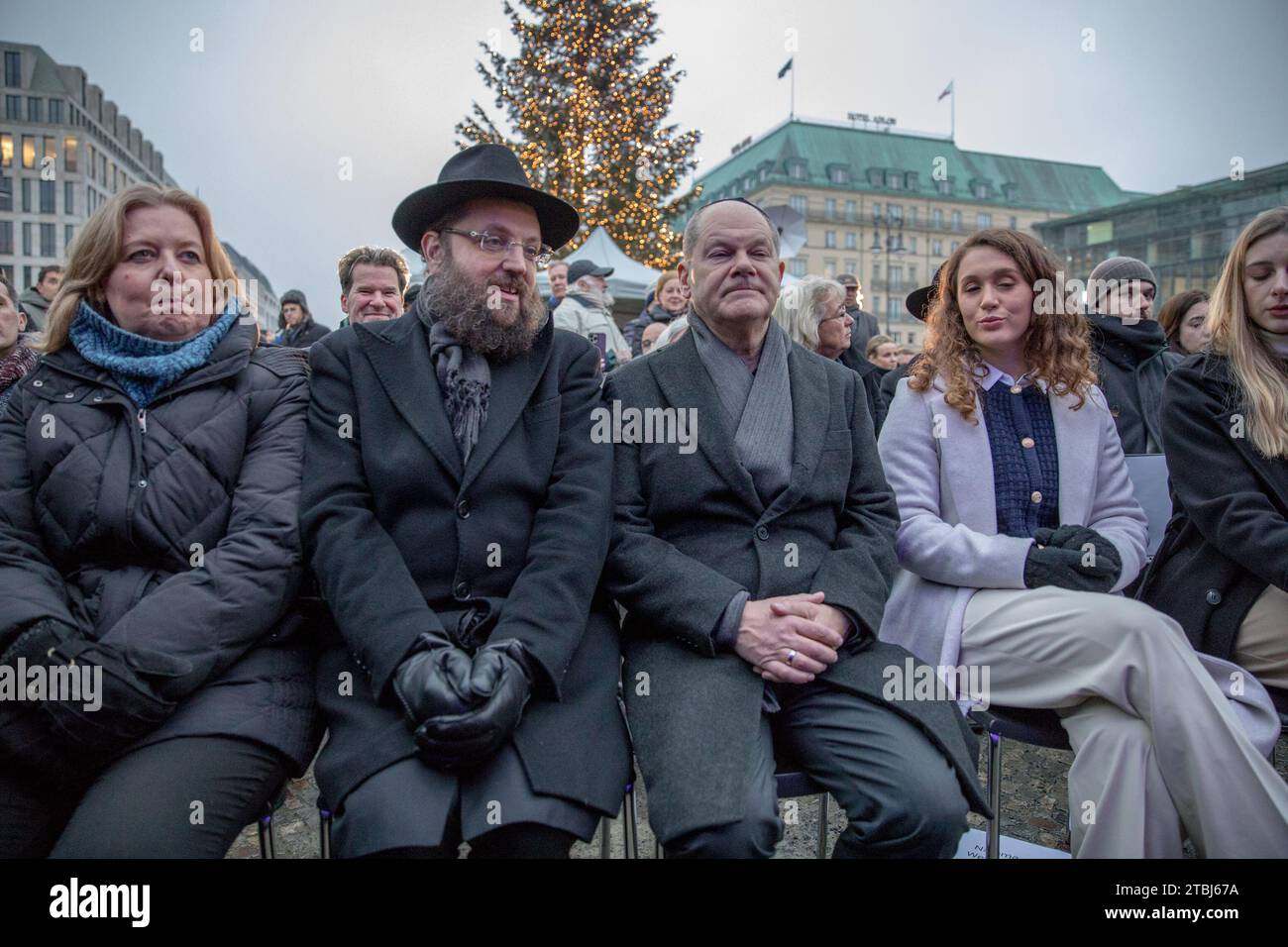 German Chancellor Olaf Scholz sits alongside Rabbi Yehuda Teichtal and ...