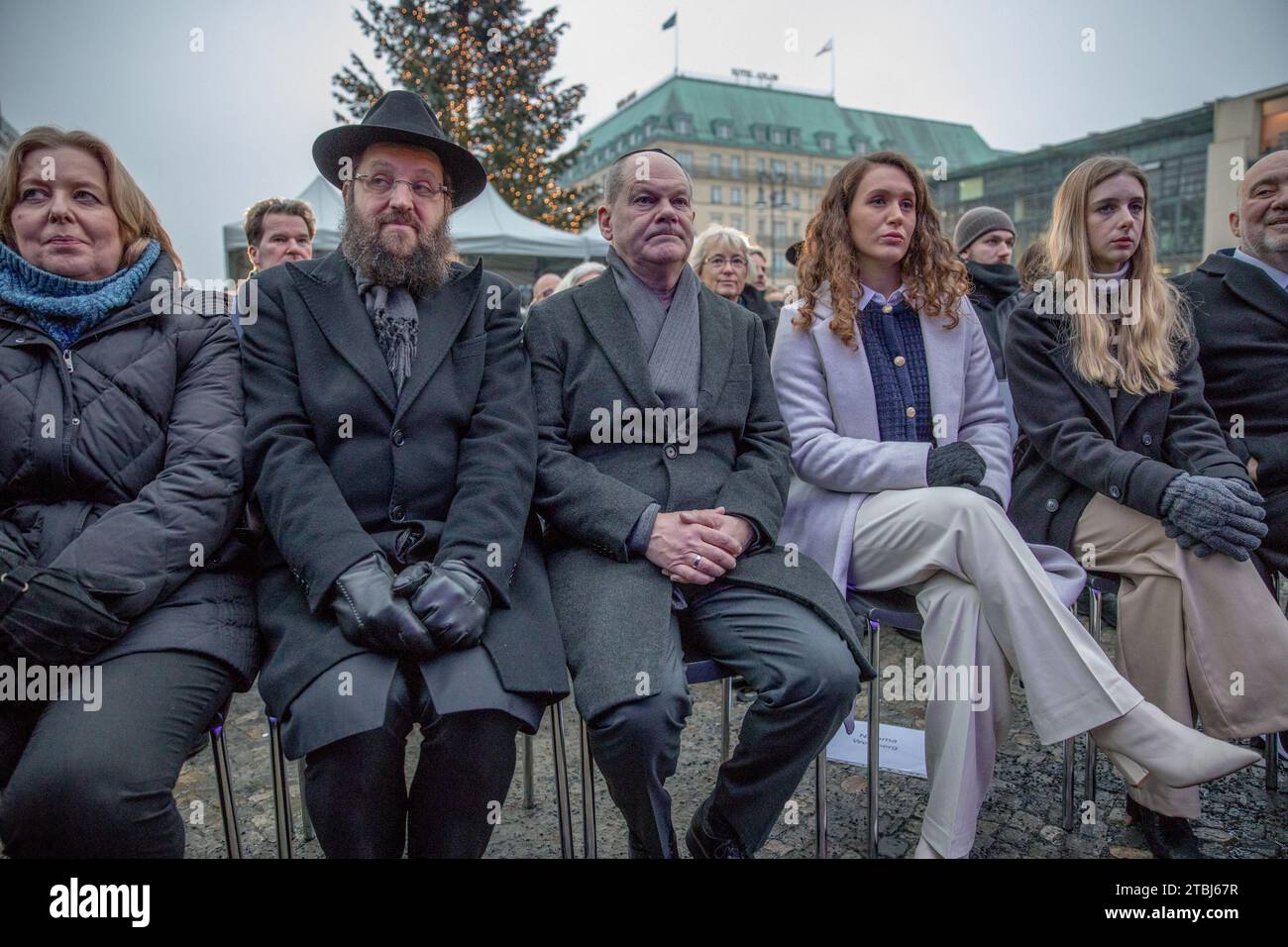German Chancellor Olaf Scholz sits alongside Rabbi Yehuda Teichtal and ...