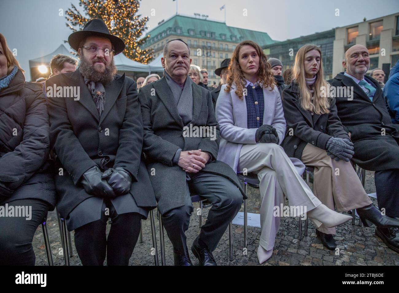 German Chancellor Olaf Scholz sits alongside Rabbi Yehuda Teichtal and ...