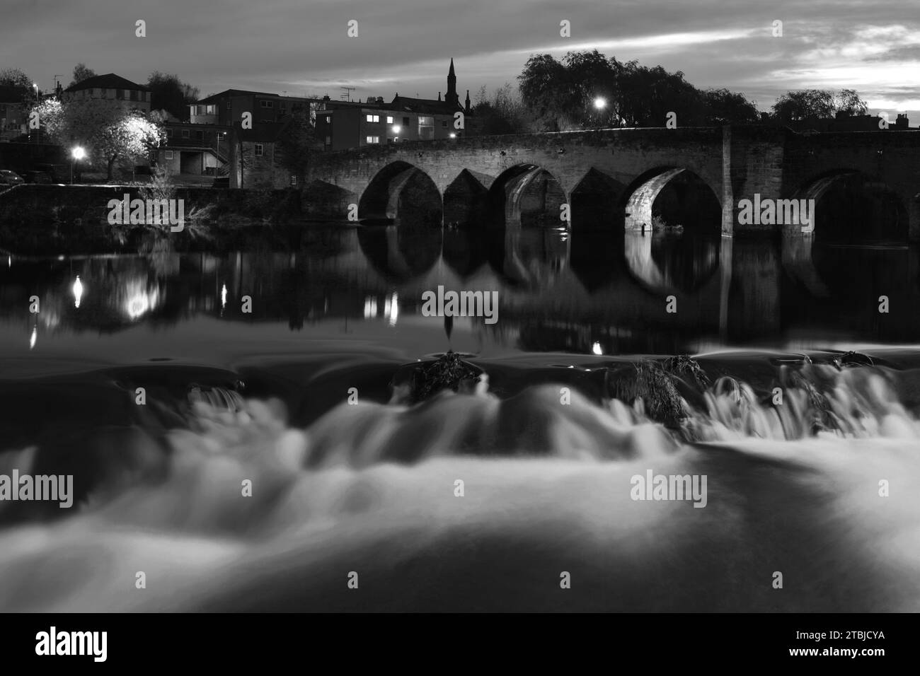 The Devorgilla bridge reflected in the river Nith, Dumfries town ...