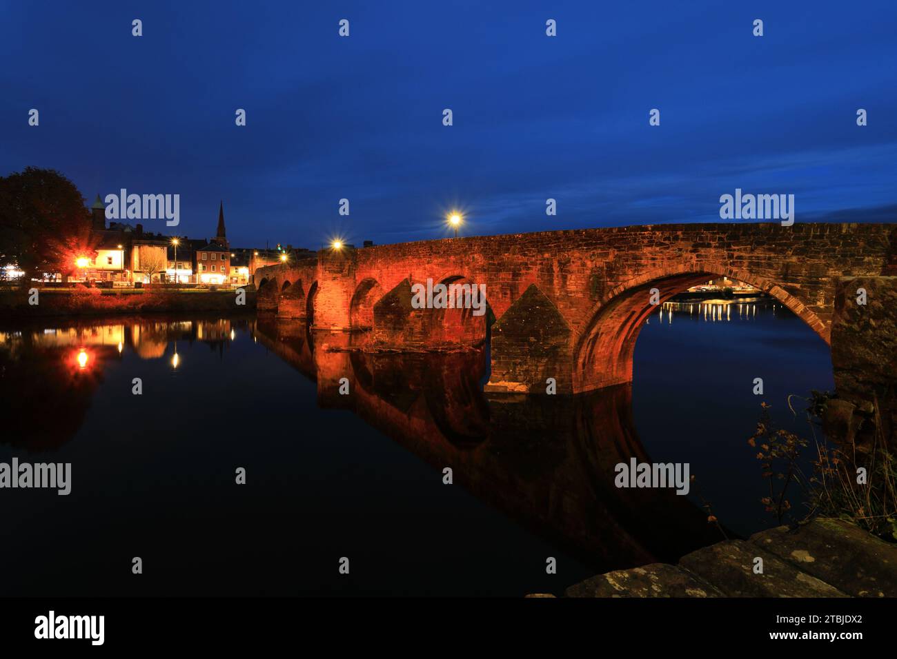 The Devorgilla bridge reflected in the river Nith, Dumfries town ...