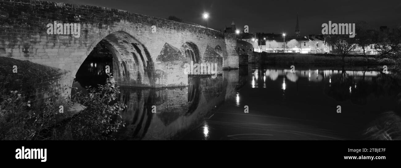 The Devorgilla bridge reflected in the river Nith, Dumfries town ...