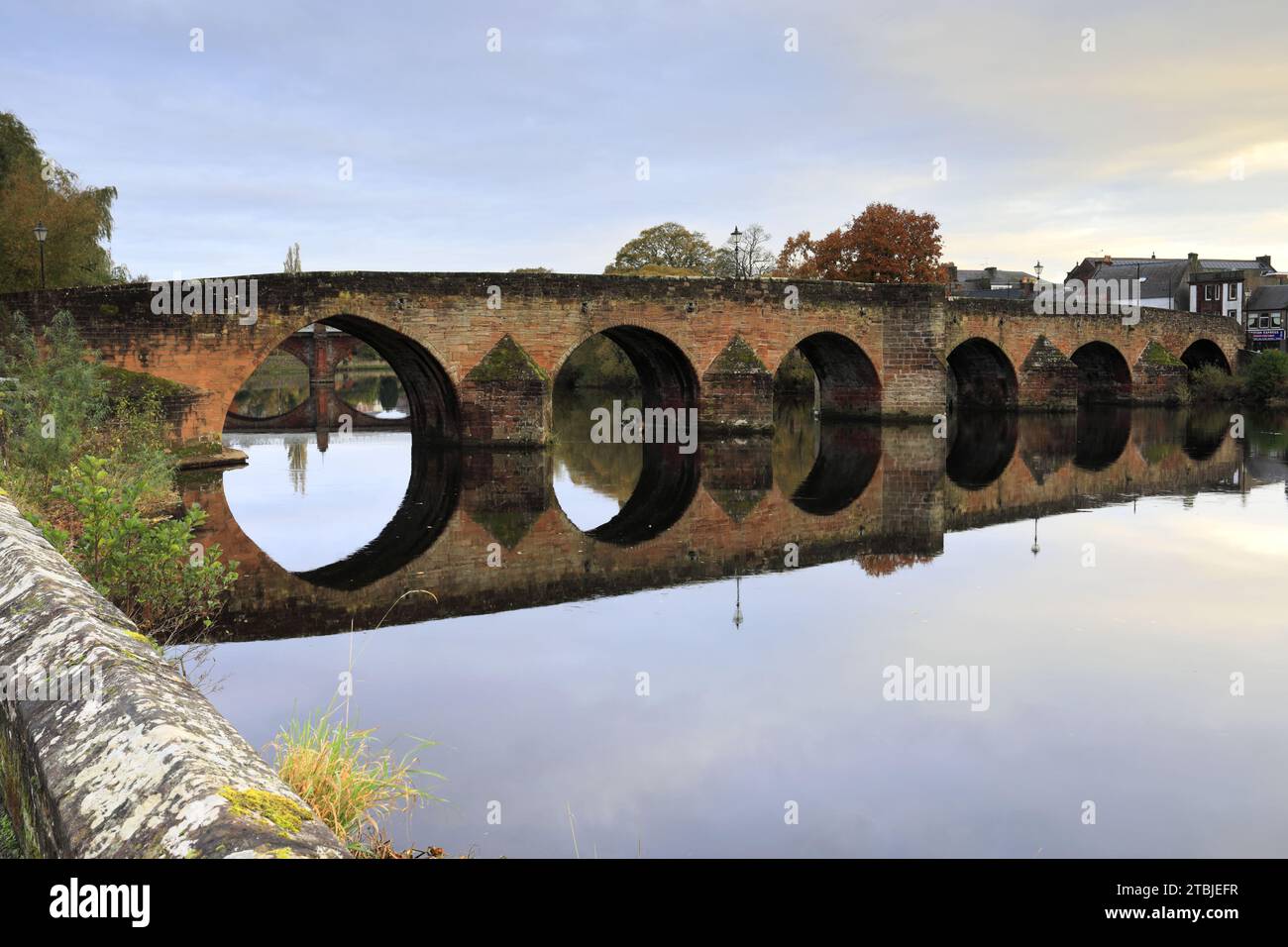The Devorgilla bridge reflected in the river Nith, Dumfries town ...