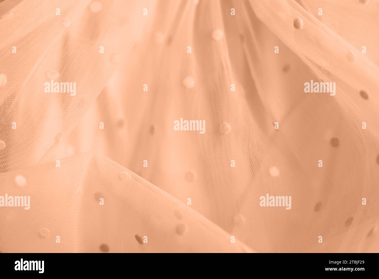 Peach fuzz, color of the year 2024, tulle fabric texture background, textile pattern, copy space ...