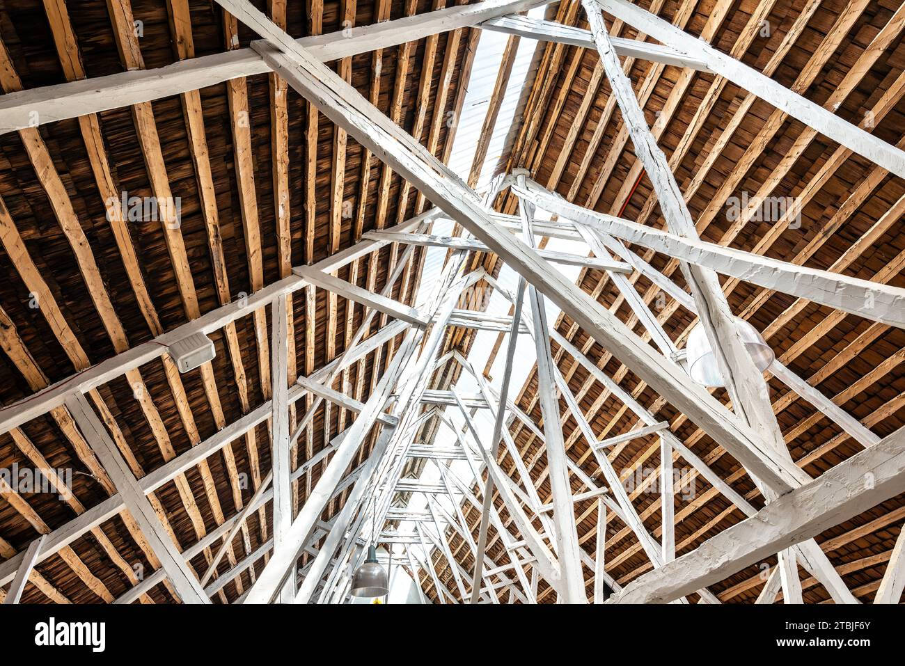 The rustic roof structure of a traditional wooden construction on the ...