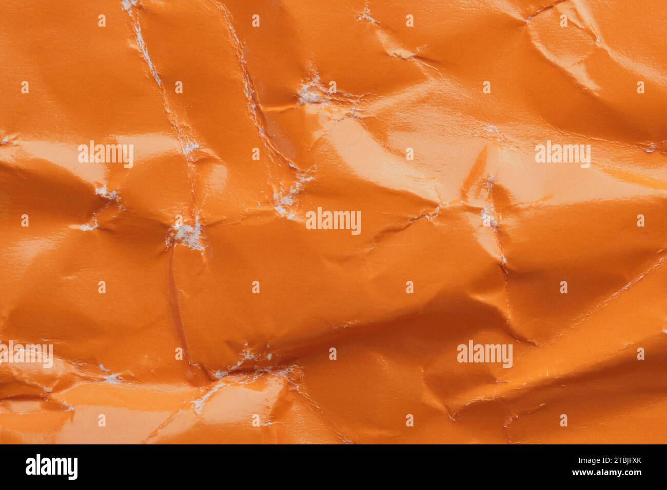 Orange crumpled paper background with folds texture Stock Photo - Alamy