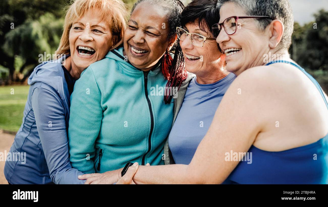 Group of senior women after sport exercise workout hugging outdoors at ...