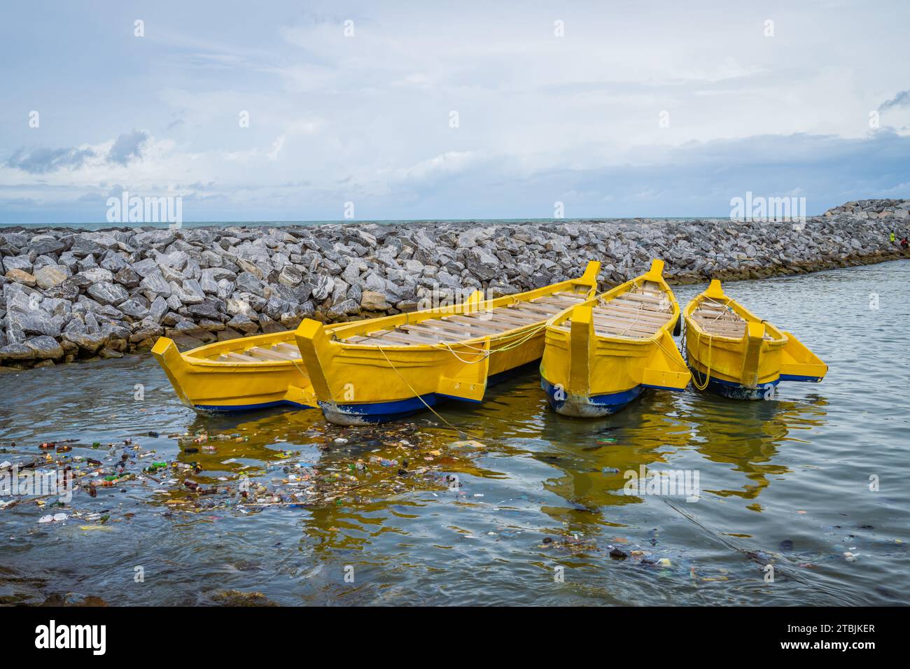 Yellow boats with rubbish pollution in water in Ghana Stock Photo - Alamy