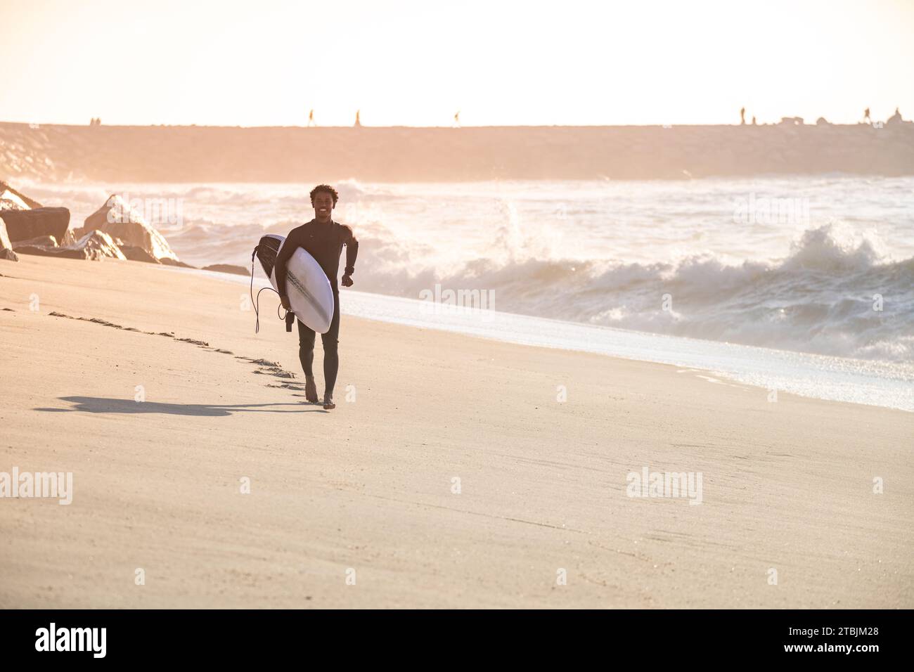 Run into ocean beach wetsuit hi-res stock photography and images - Alamy
