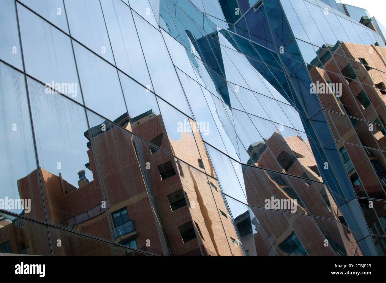 Brick building reflection on glass building Stock Photo - Alamy
