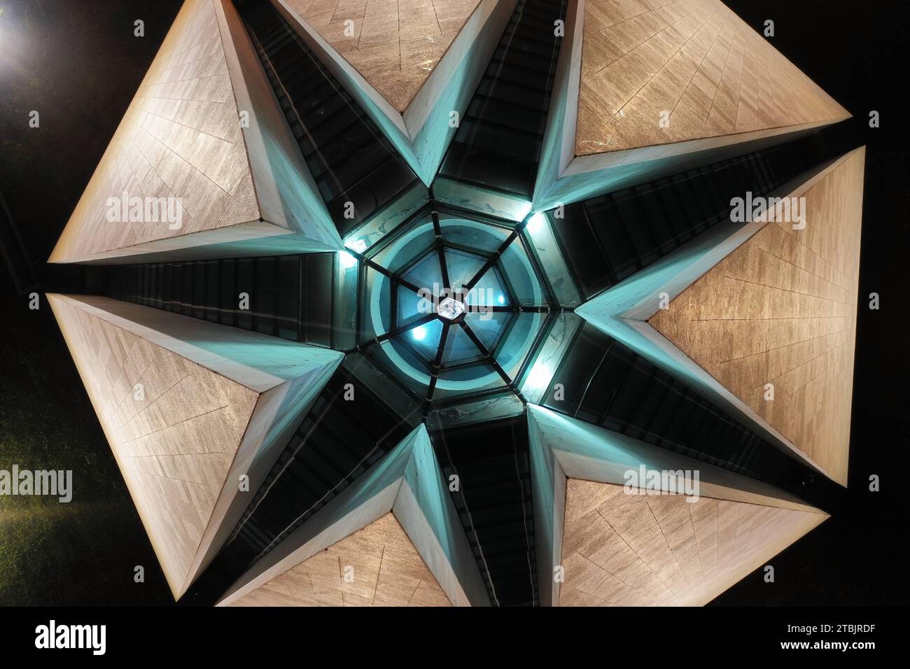 This stock photo features a star-shaped object mounted to a dark wall ...