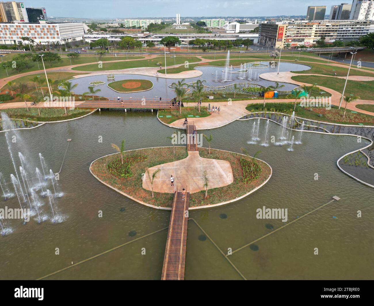 A scenic pathway winding through a lush park, with a sprawling open ...