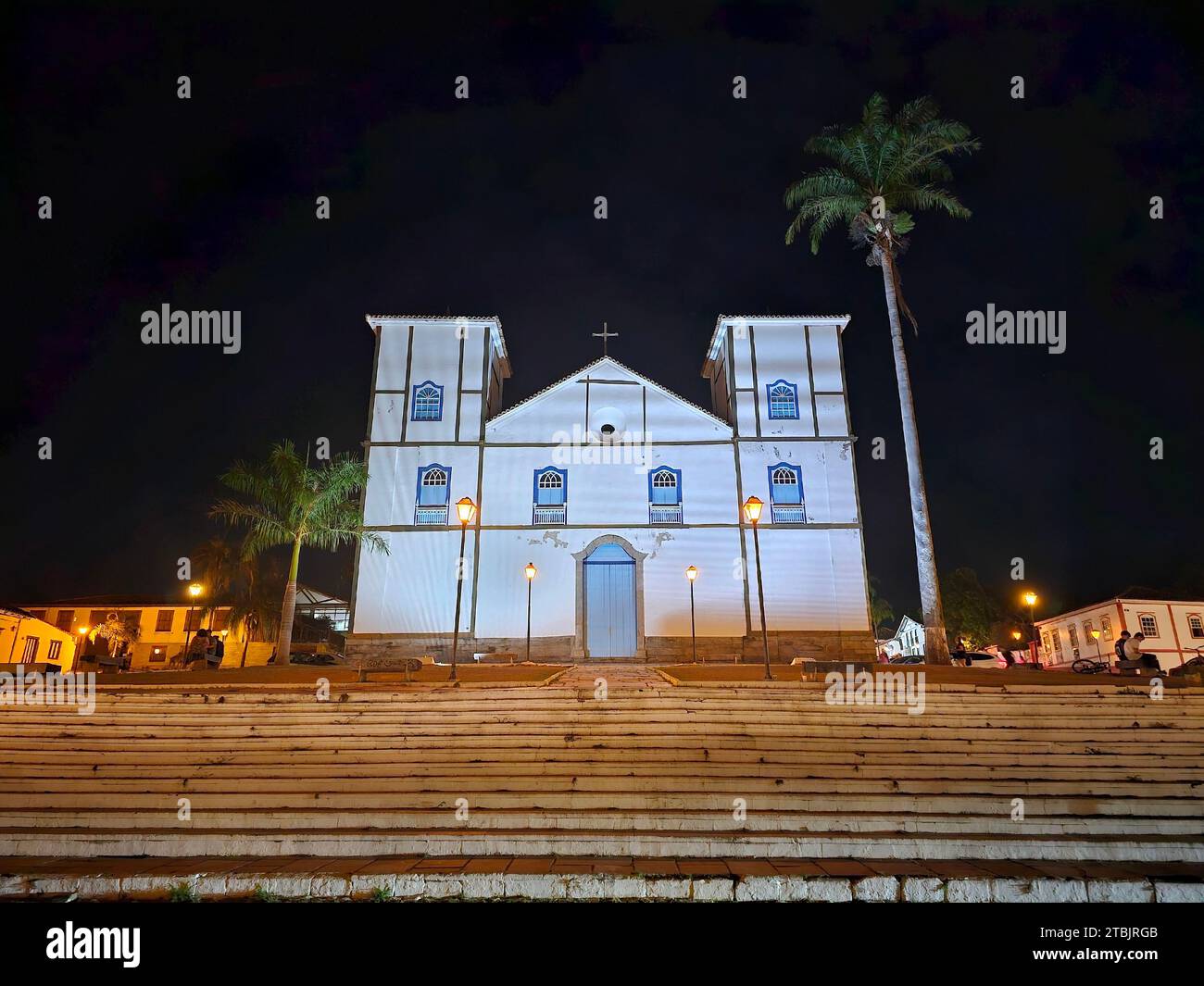 An illuminated church with illuminated palm trees in the background ...