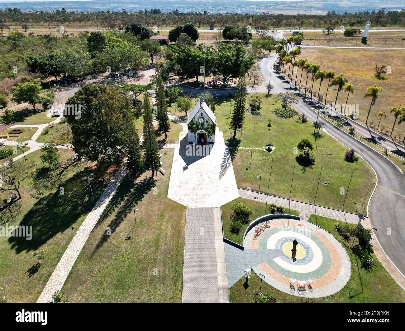 Aerial view of a small monument surrounded by trees, with a parking lot ...