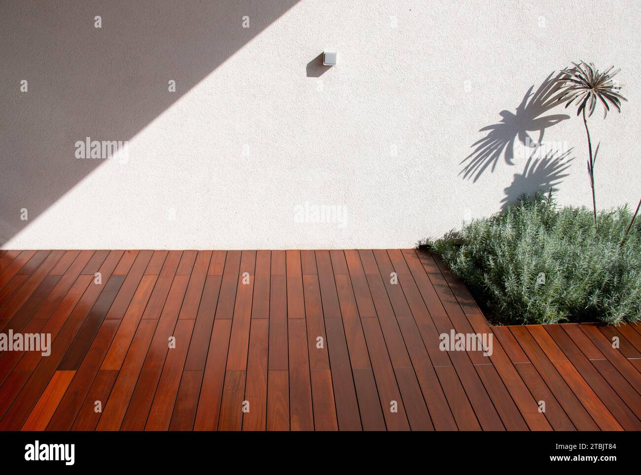 House patio deck decorative detail, wood planks against white wall with ...