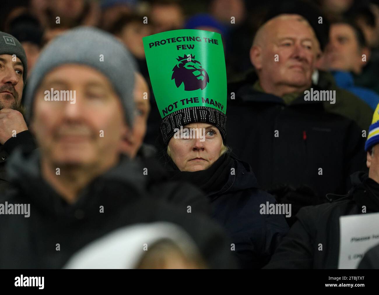 Everton hold up signs protesting the Premier League during the Premier ...