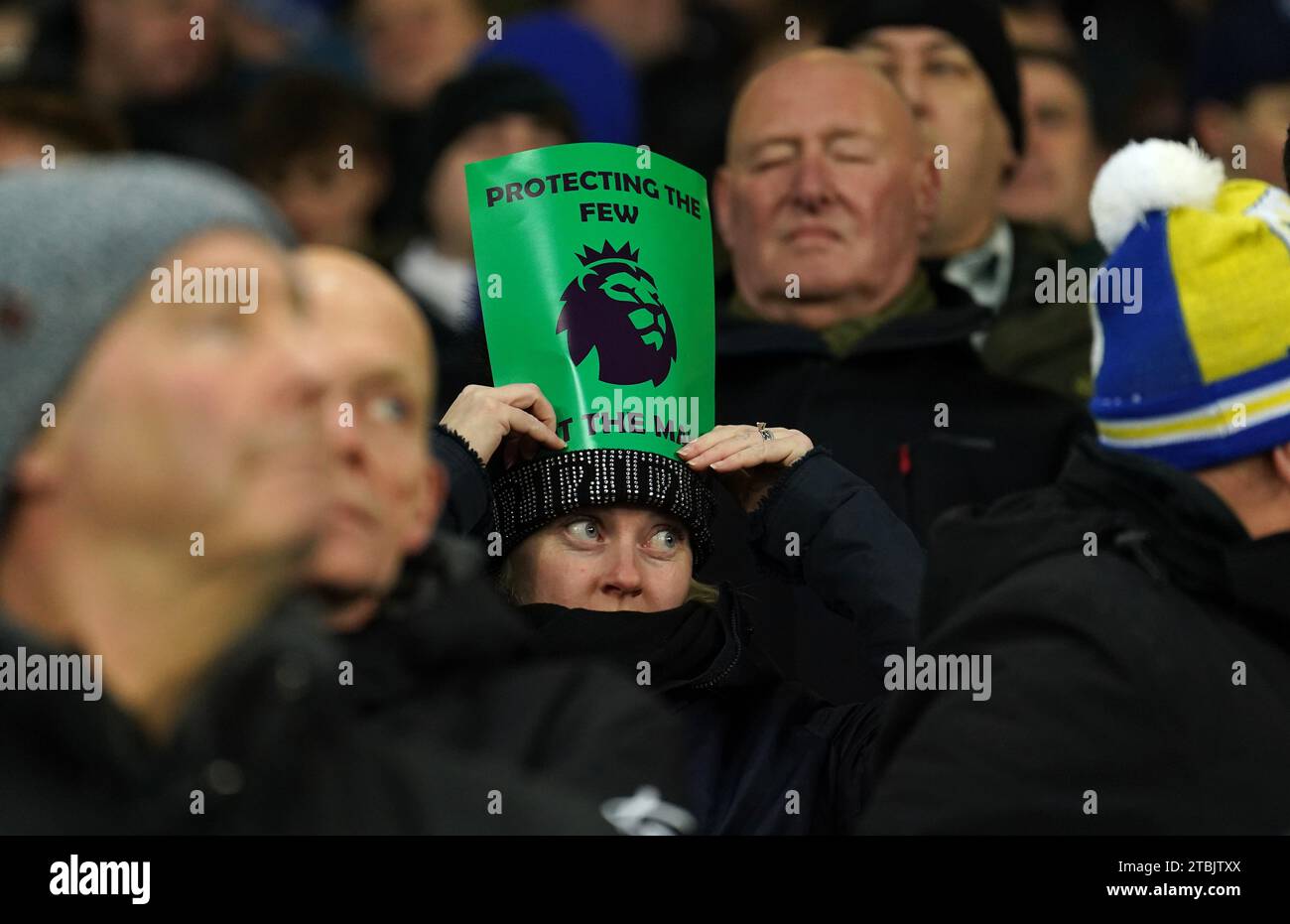 Everton hold up signs protesting the Premier League during the Premier ...
