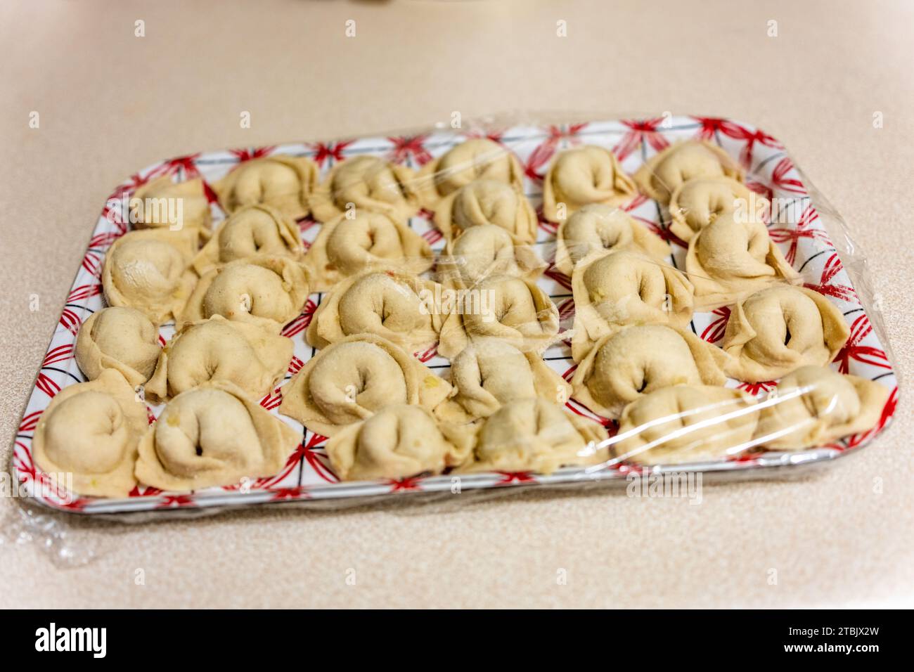 A tray of freshly made Uyghur Chöchure, a wonton or tortellini type ...