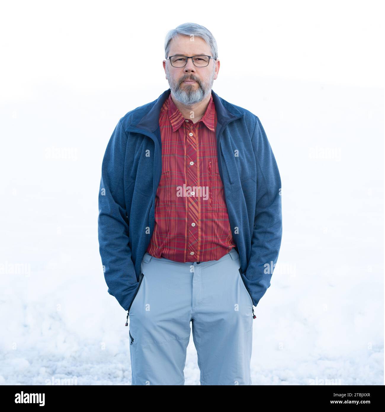 Man, 56 years, grey hair and beard, standing outside in winter with ...