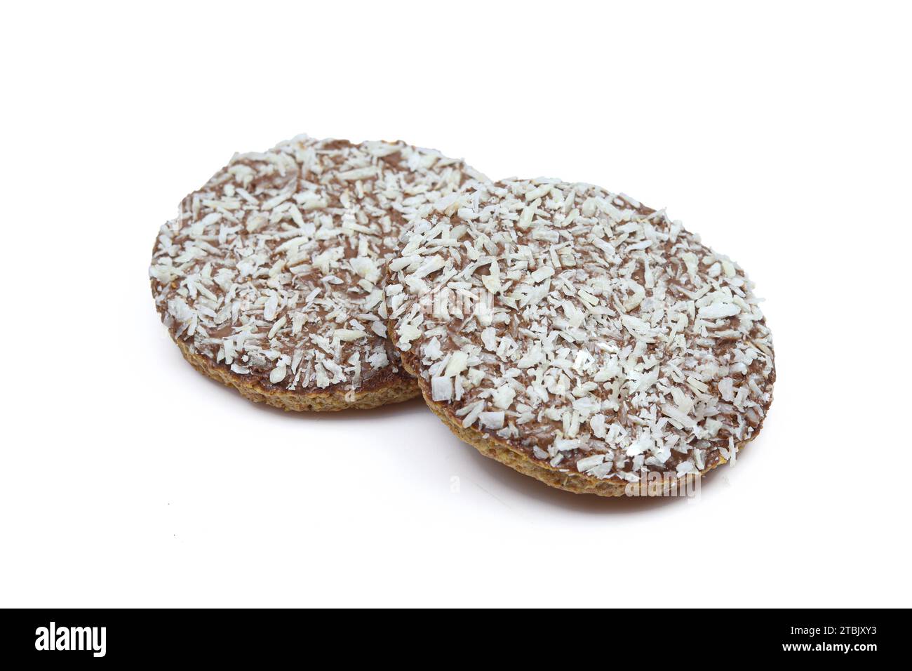 Two chocolate biscuits sprinked with coconut flakes isolated on white ...
