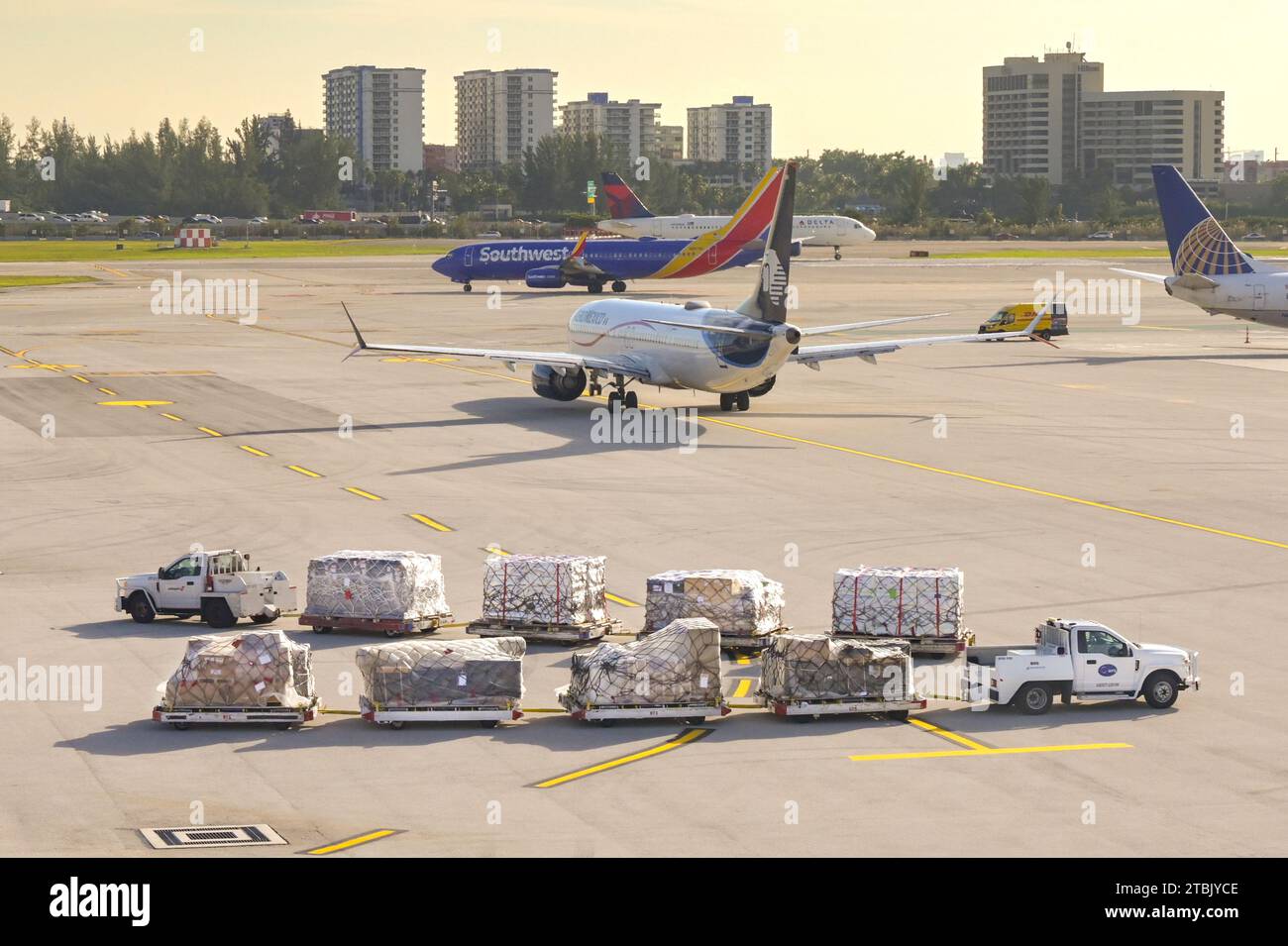 Miami, Florida, USA - 4 December 2023: Trucks towing trailers with air ...
