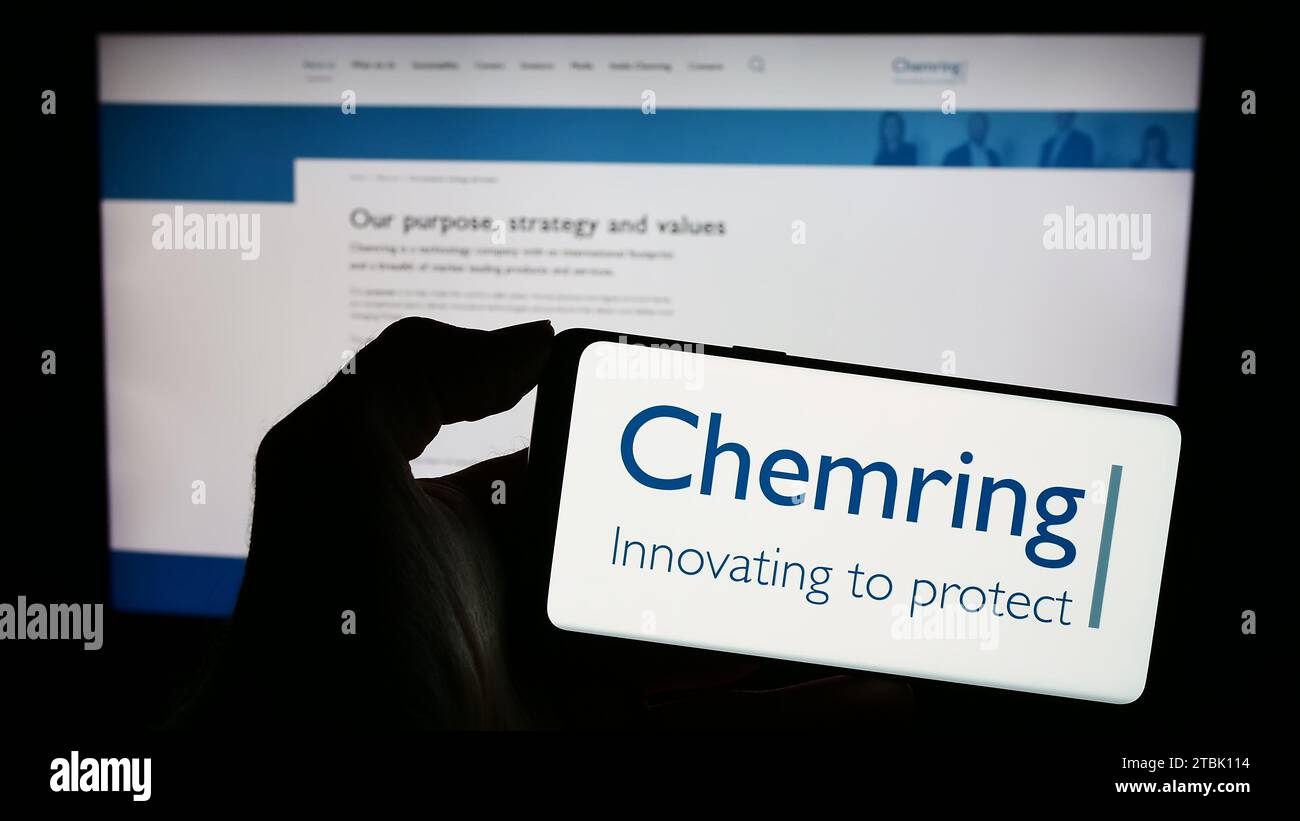 Person holding smartphone with logo of British aerospace and defence ...