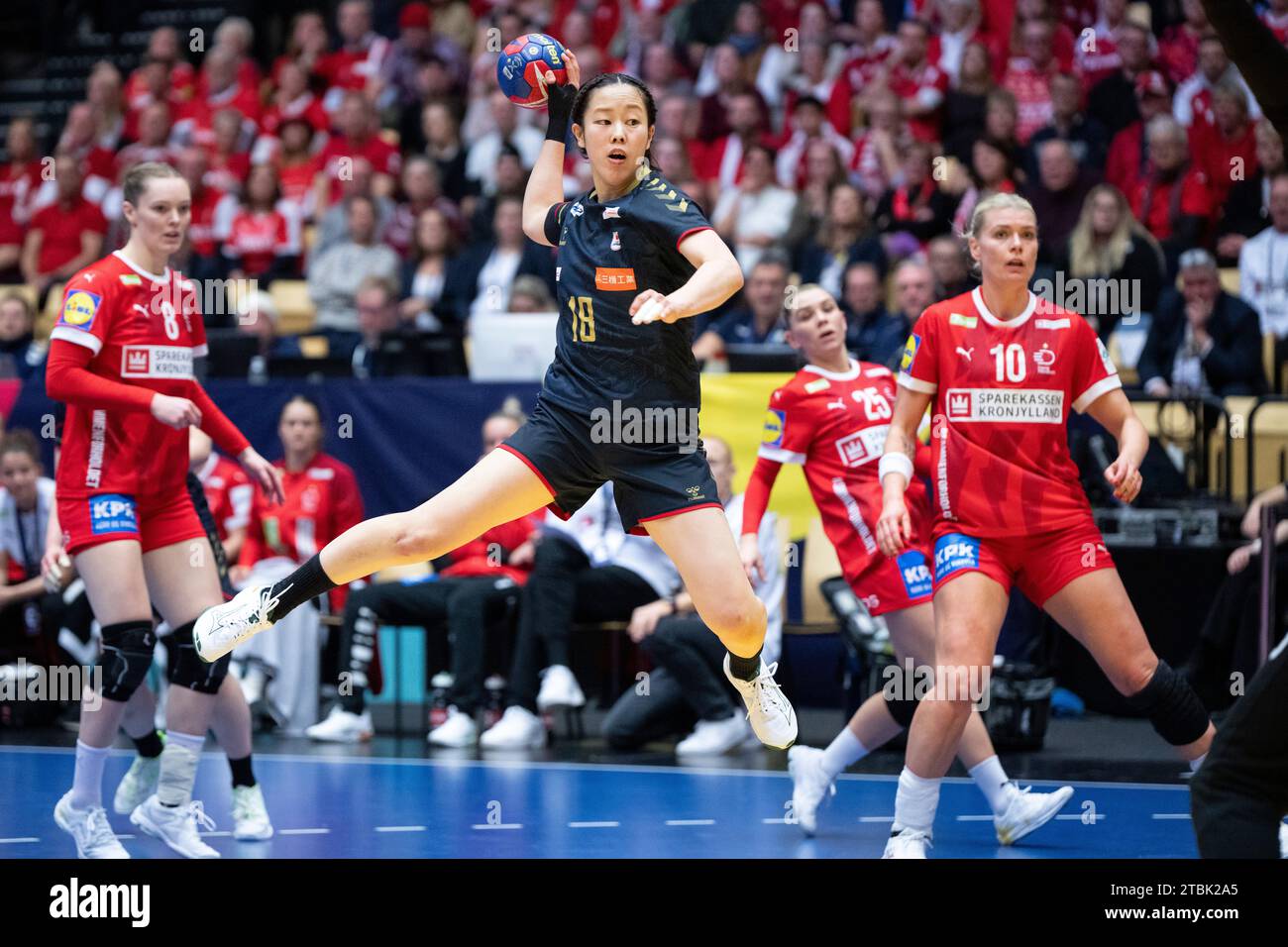 Japans Hikaru Matsumoro shoots in front of Denmarks Anne Mette Hansen, Trine OEstergaard and ...