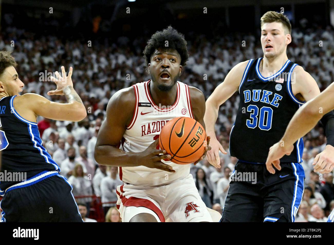 Arkansas forward Makhi Mitchell (15) drives past Duke defenders during ...
