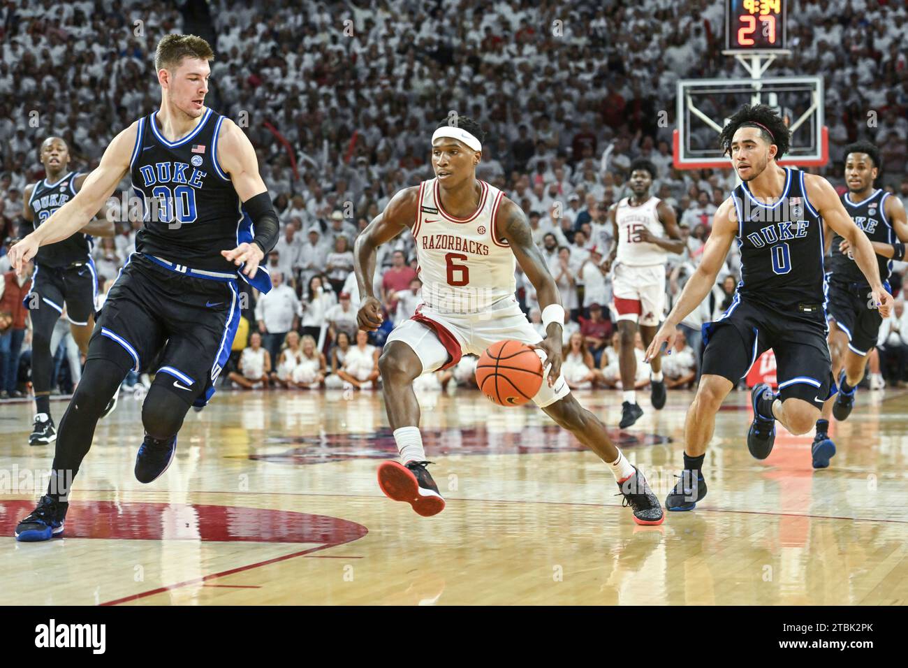 Arkansas guard Layden Blocker (6) tries to drive past Duke defenders ...