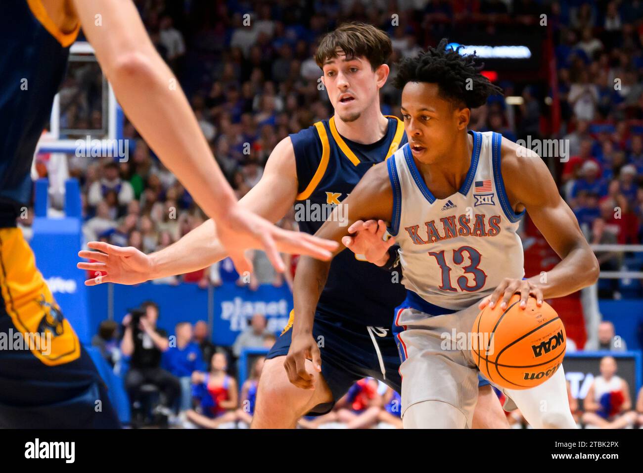 Kansas guard Elmarko Jackson (13) drives past Kansas City guard Cameron ...