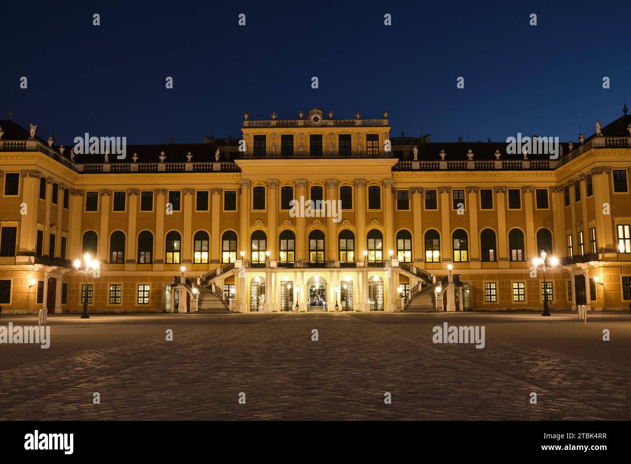 Schonbrunn palace front building facade at night, a popular tourist ...