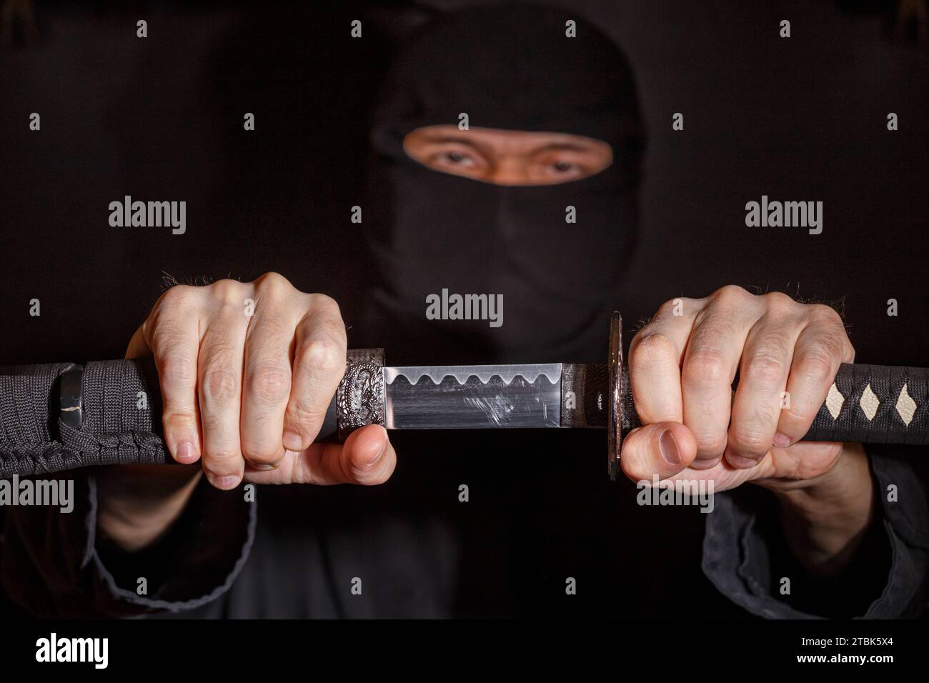 Ninja ready to fight, holding a Japanese sword. Photo of a warrior ...