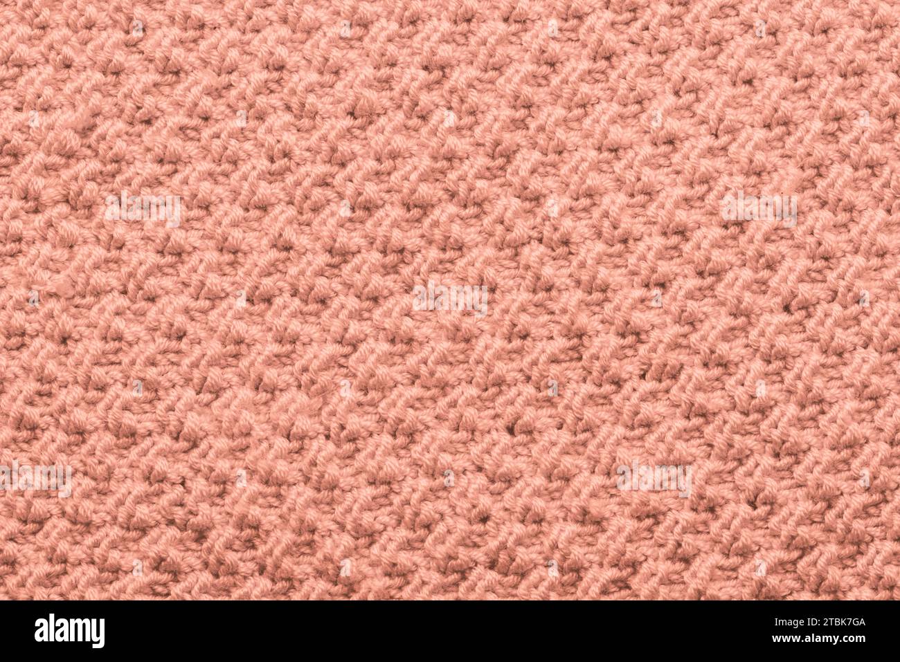 Trendy color of 2024 Year Peach Fuzz. Knit texture of wool knitted fabric with pattern ...