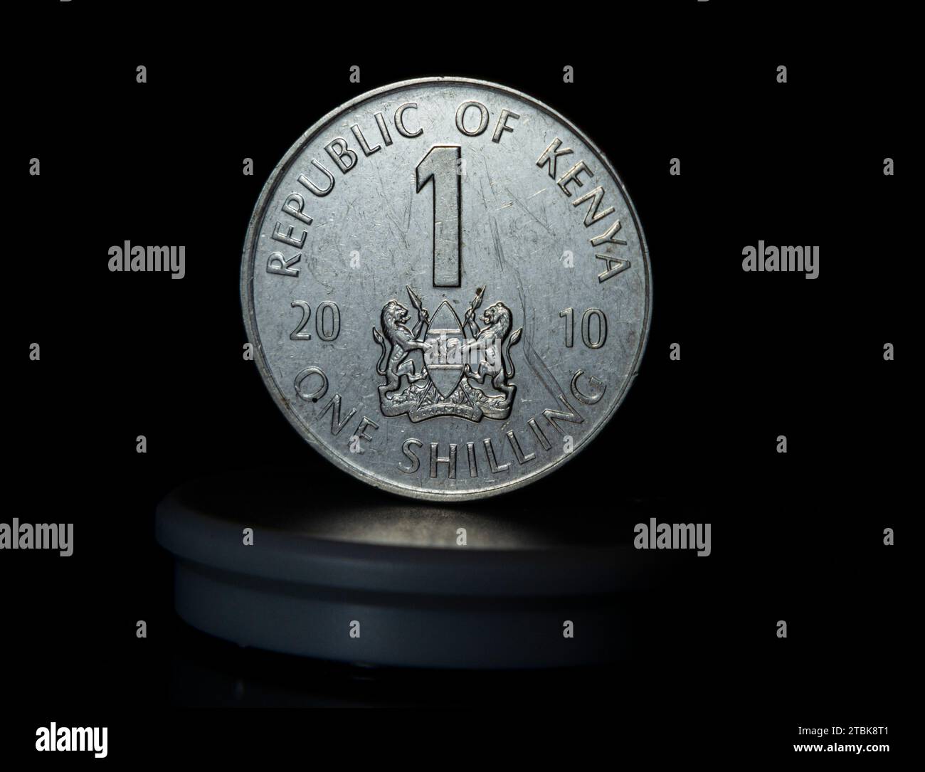 A close-up image of two one-penny coins lying on a reflective surface ...
