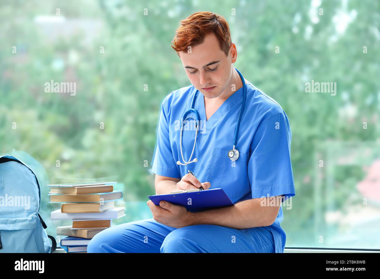 Male medical student with clipboard at university Stock Photo - Alamy