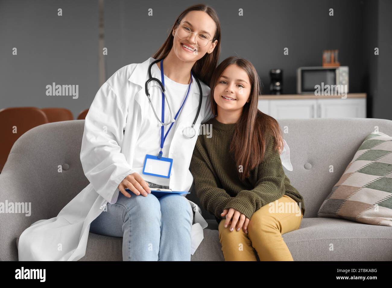 Sick little girl with doctor hugging at home Stock Photo - Alamy