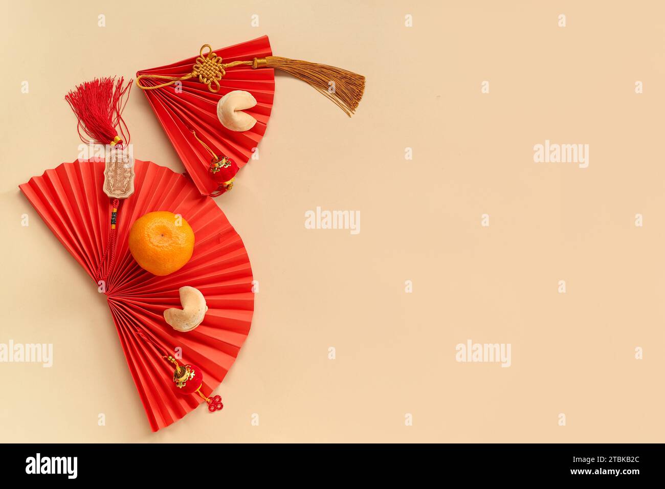 Fortune cookies with mandarin and Chinese symbols on beige background ...