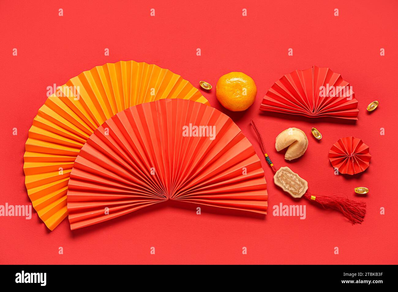 Fortune cookie with mandarin and Chinese symbols on red background. New ...