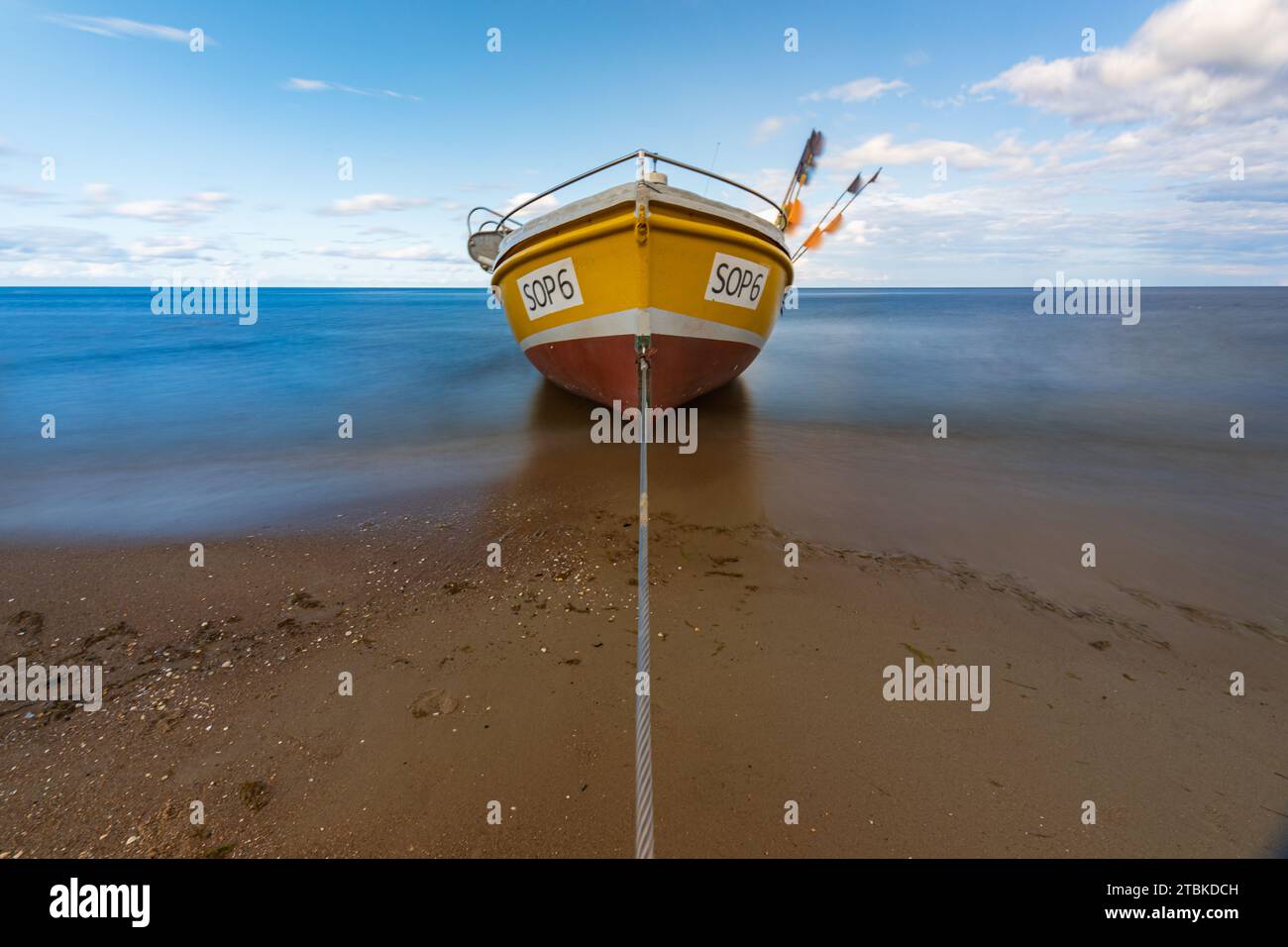 Sopot, Poland - July 22 2023: Alone yellow red and white boat hooked by ...