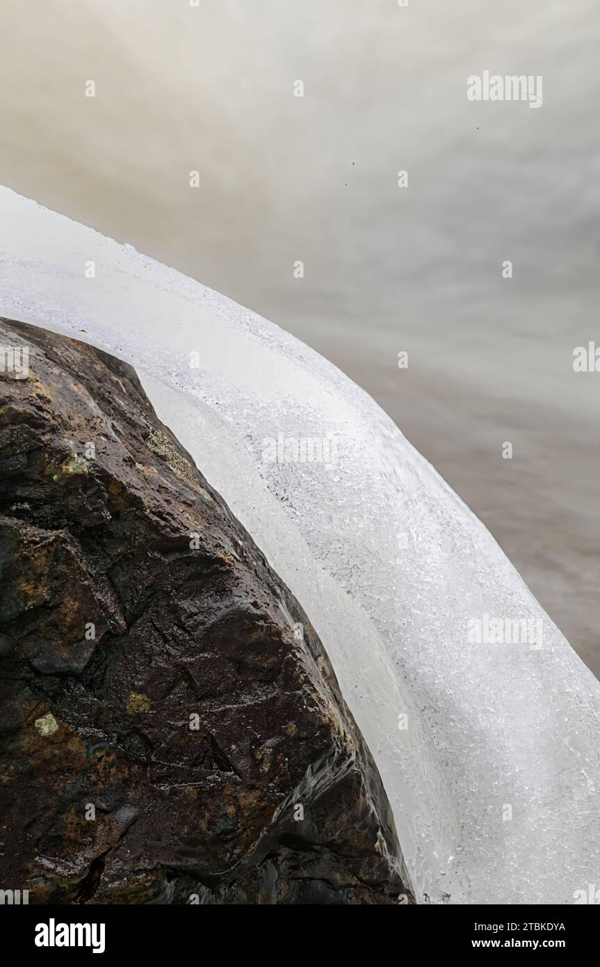 Ice on a rock with a white background Stock Photo - Alamy
